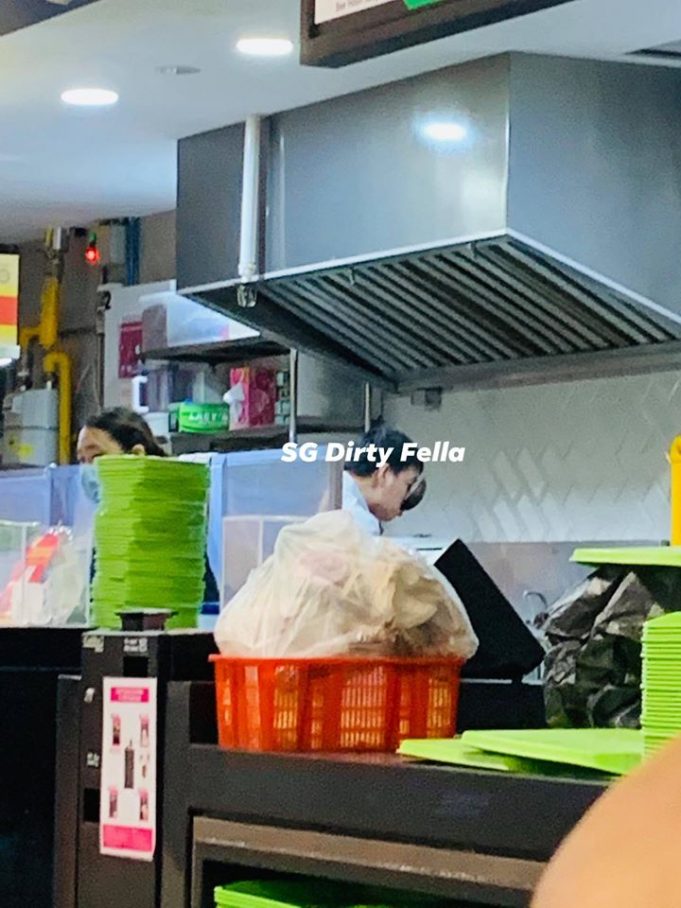 CHEF AT MALA STALL AT PAYA LEBAR SQ USE LADLE TO TASTE SOUP. NO MASK WORN
