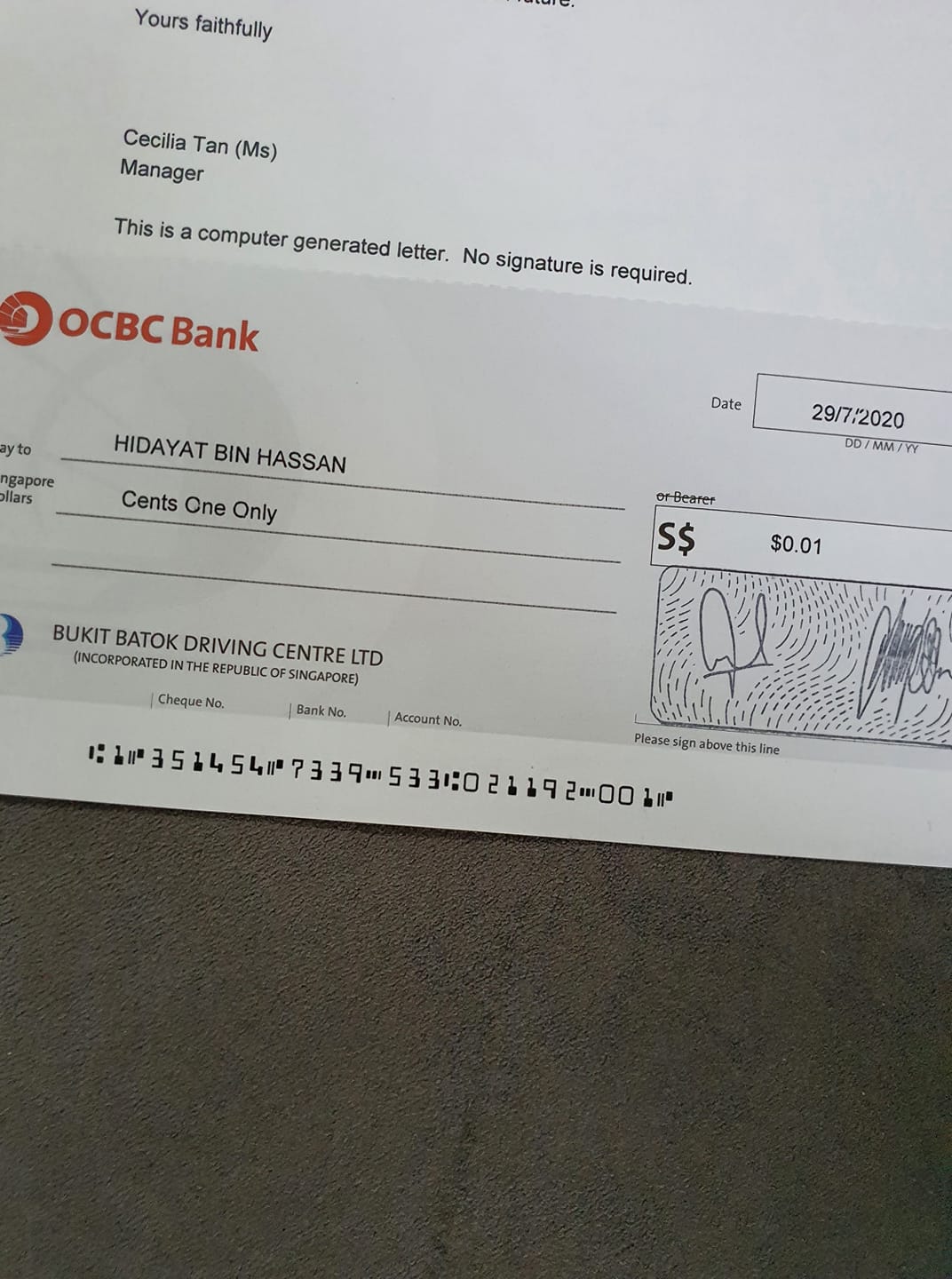 MAN RECEIVES OCBC CHEQUE FOR SGD$0.01 FROM BUKIT BATOK DRIVING CENTRE