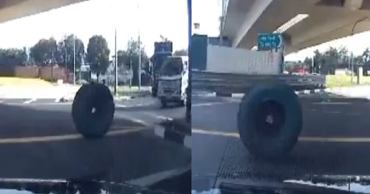 TYRE FALL OFF TRUCK AND ROLL ON THE ROAD PAST BUSY JUNCTION