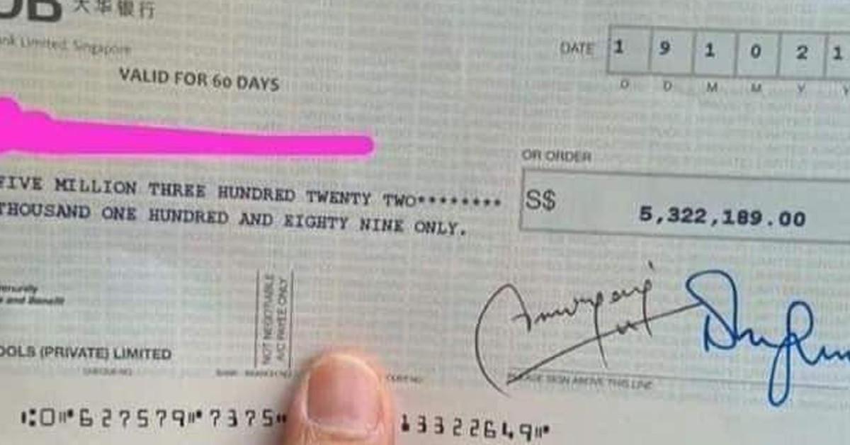 ONE OF THE WINNERS WHO WON TOTO $5M SHOWS HIS CHEQUE