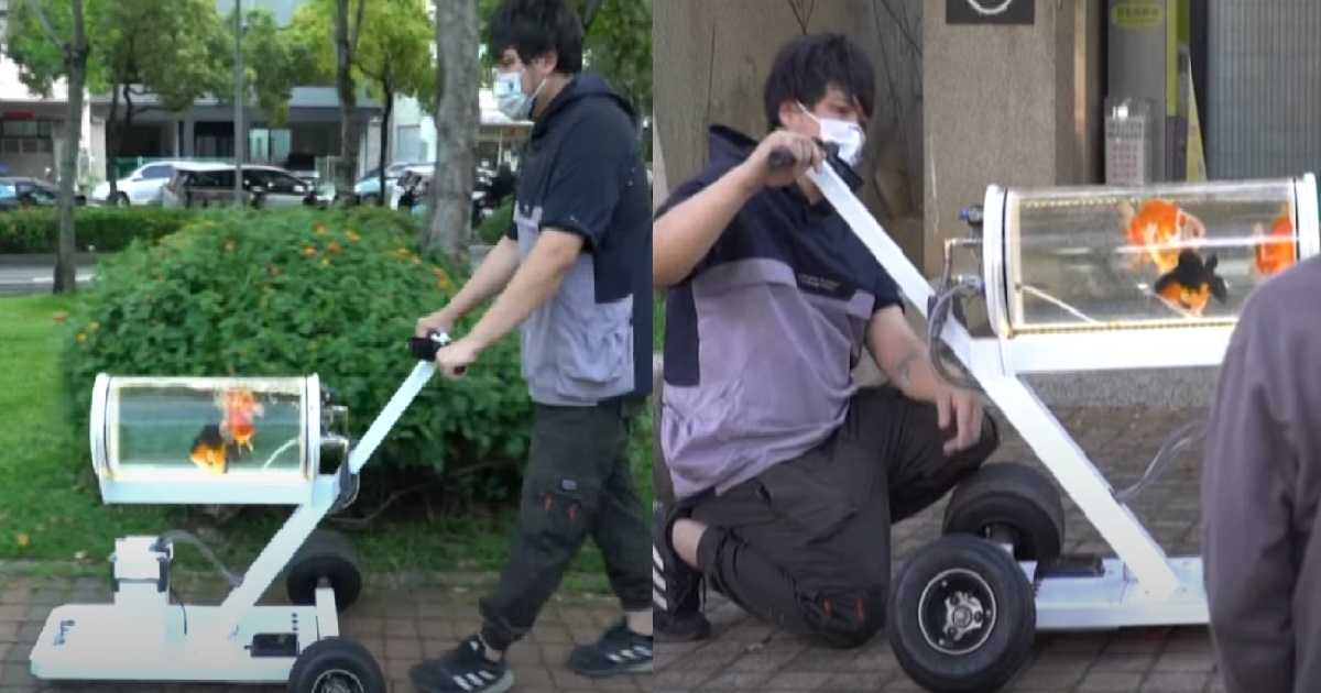 MAN BRINGS HIS PET FISH OUT FOR A WALK WITH A "FISH STROLLER" THAT HE ...