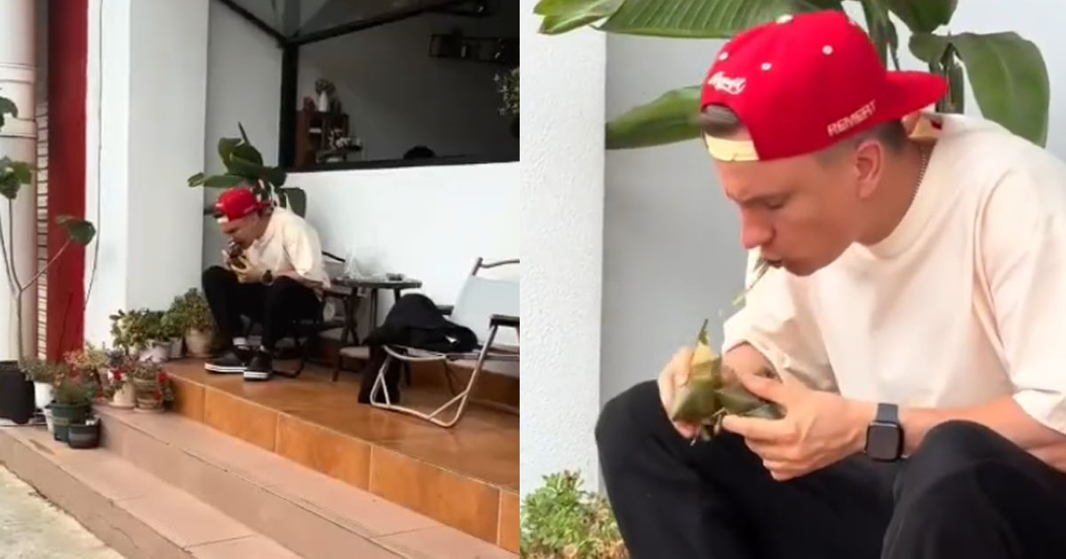 TOURIST EATING BA ZHANG AKA DUMPLING WITH THE LEAF WRAPPING